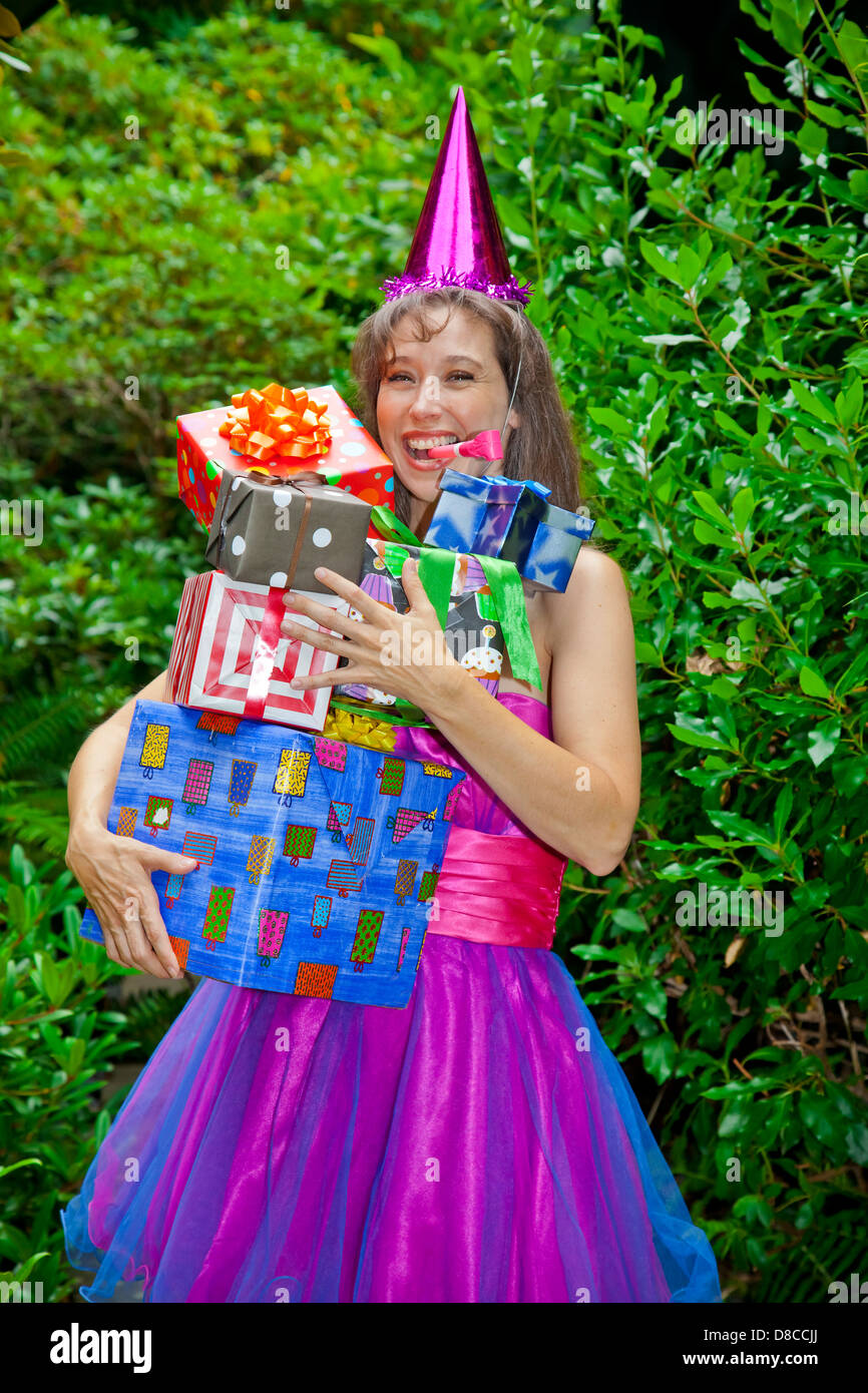 Woman in party clothes holding presents Stock Photo - Alamy