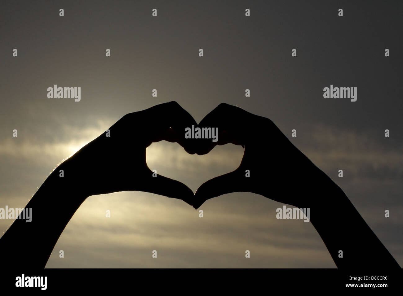 Heart hands in sun silhouette hi-res stock photography and images - Alamy