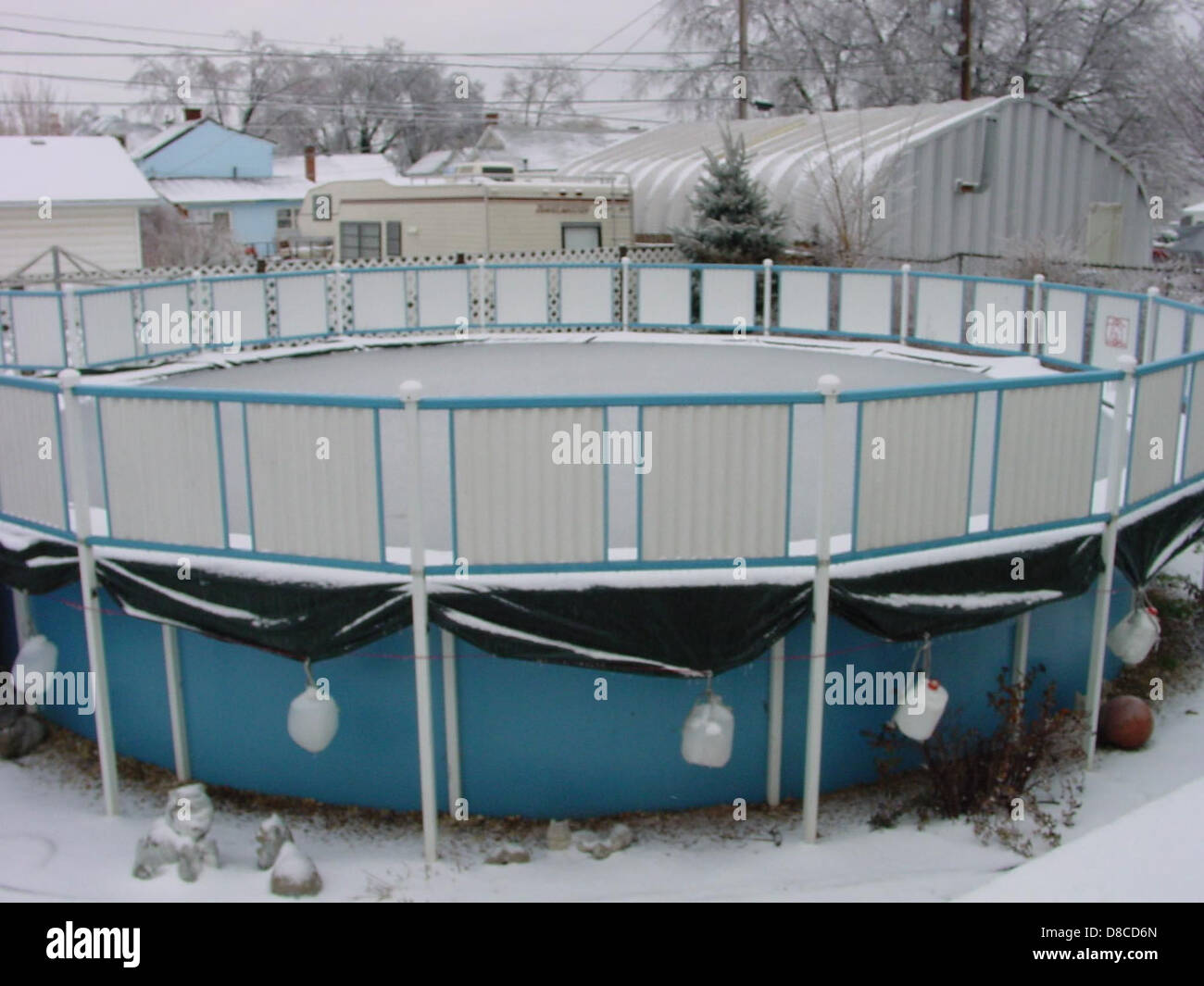 An above-ground pool set up in a residential backyard, offering a ...