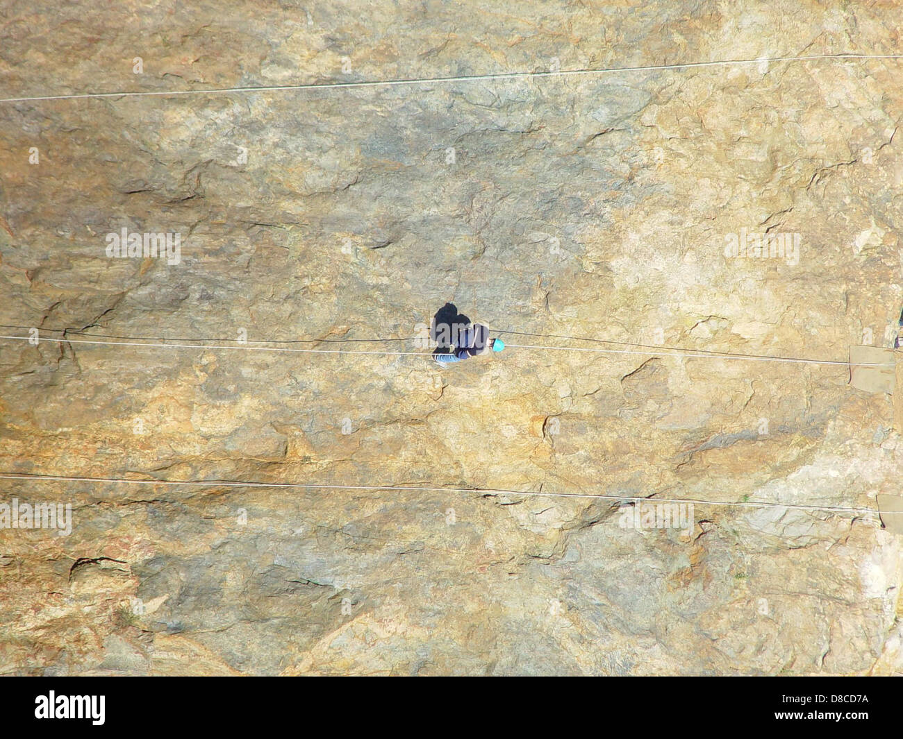 An abseiler named Royce descending a steep wall, showcasing a rock ...
