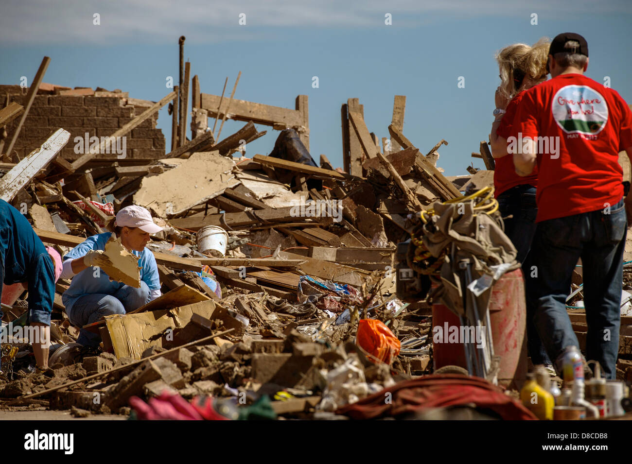 Residents sift through the wreckage of their homes in the aftermath of ...