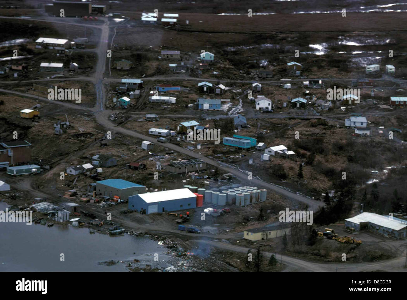 An aerial view of a small village surrounded by greenery. The image ...