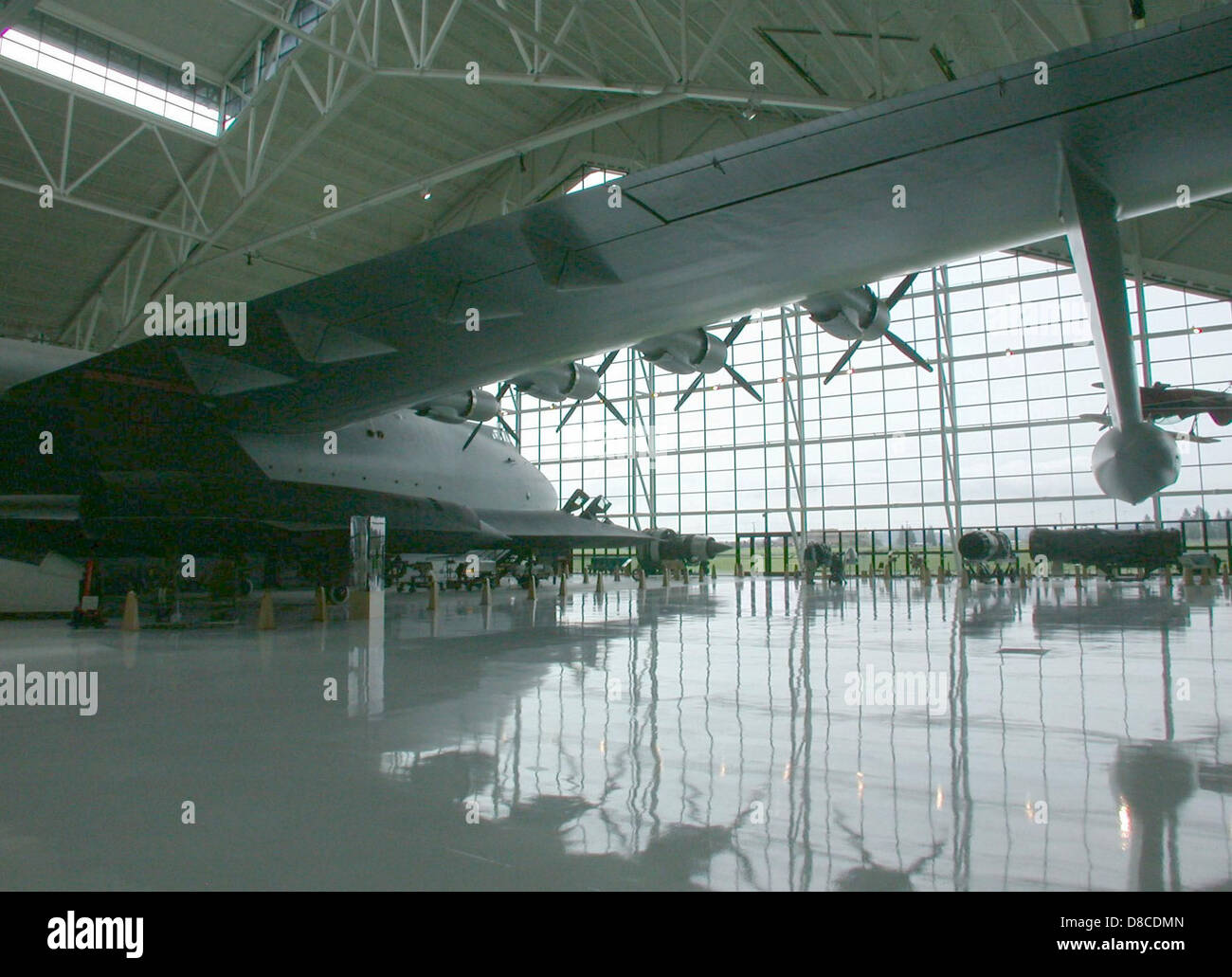 An aeroplane is parked inside a hangar, with the aircraft visible ...