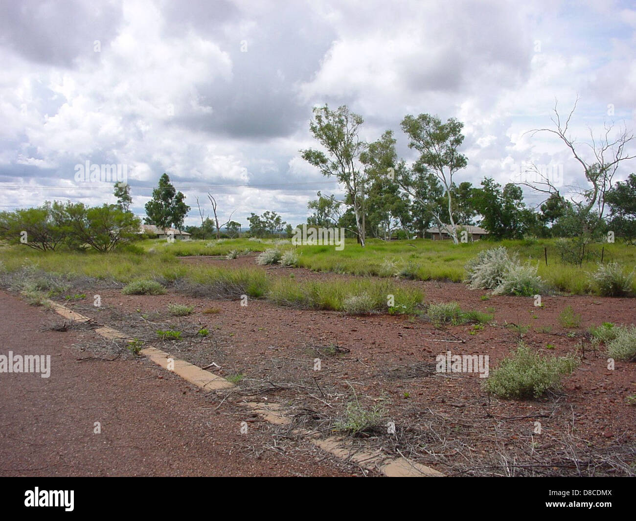 This image shows a dirt road winding through the African landscape. The ...