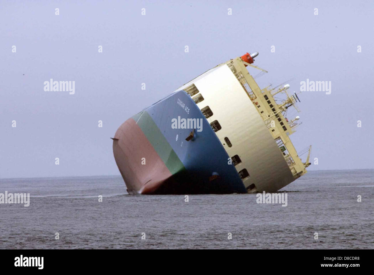 A ship stranded aground, its hull partially visible above the waterline ...