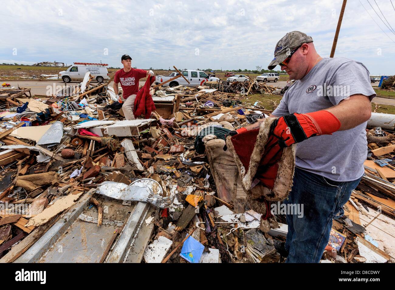 Residents sift through the wreckage of their home in the aftermath of ...
