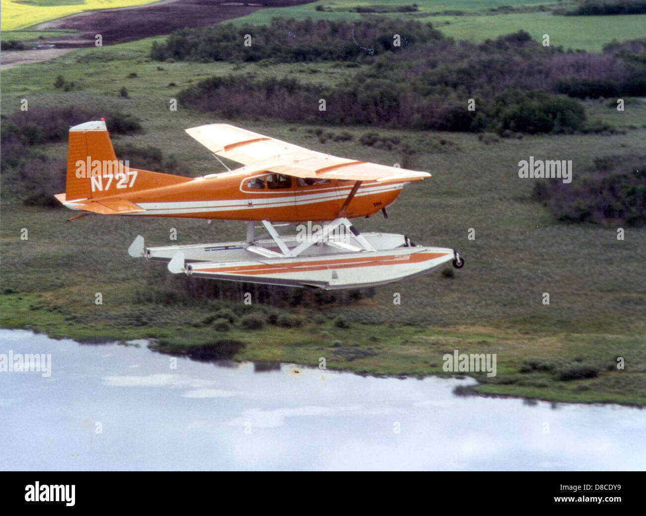 An aircraft is seen flying over large bodies of water, providing a bird ...
