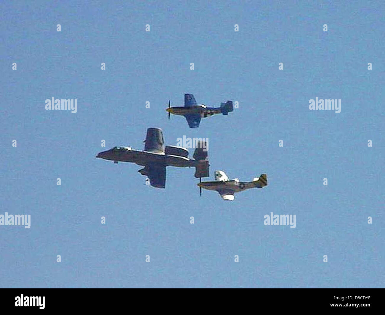 A group of airplanes flying at a low altitude in the sky. The aircraft ...
