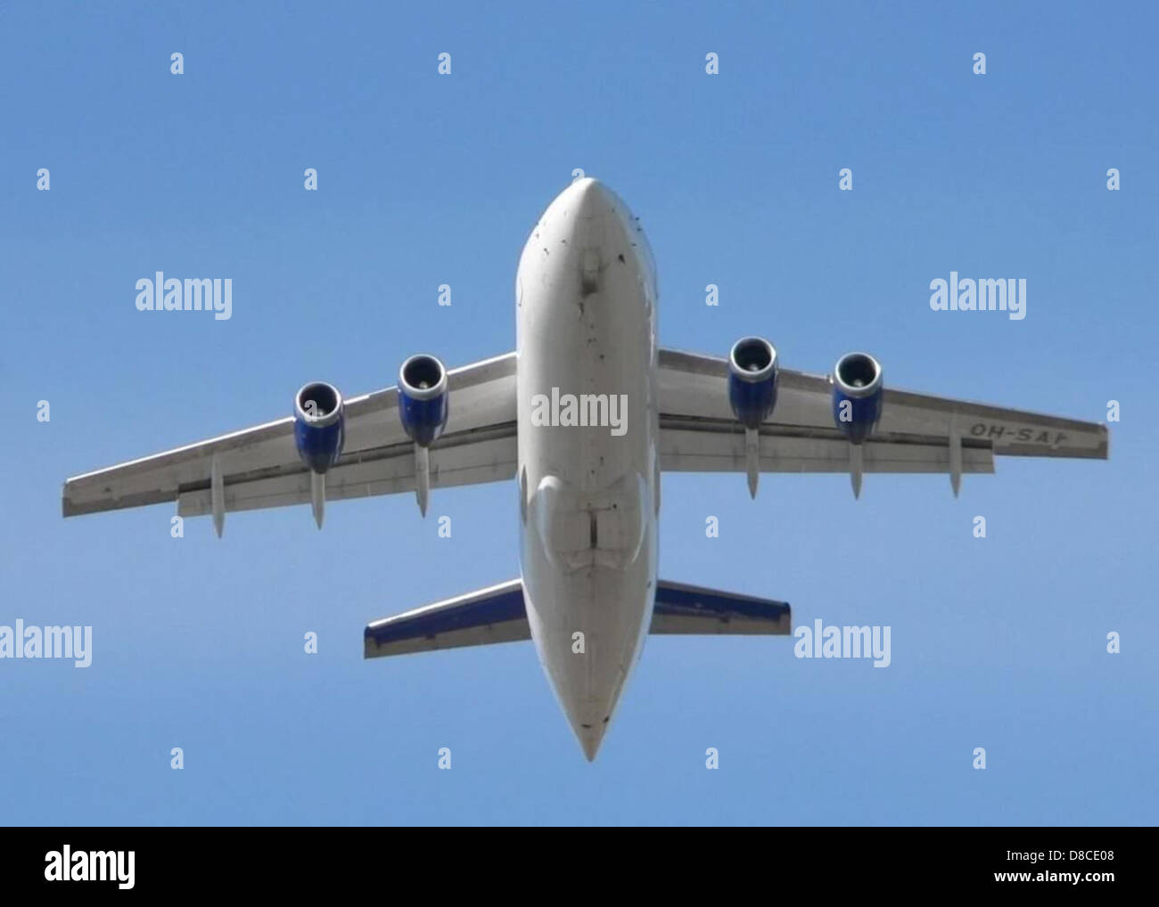 An airplane is captured taking off at high altitude, with the vast sky ...
