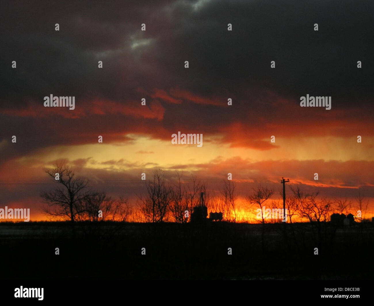 The Alberta sunset casts vibrant orange and pink hues across the sky ...