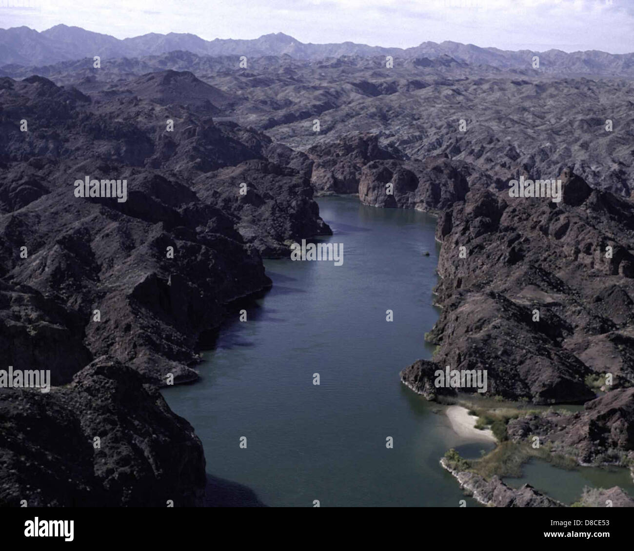 A scenic view along the banks of the Colorado River, showing the rugged ...