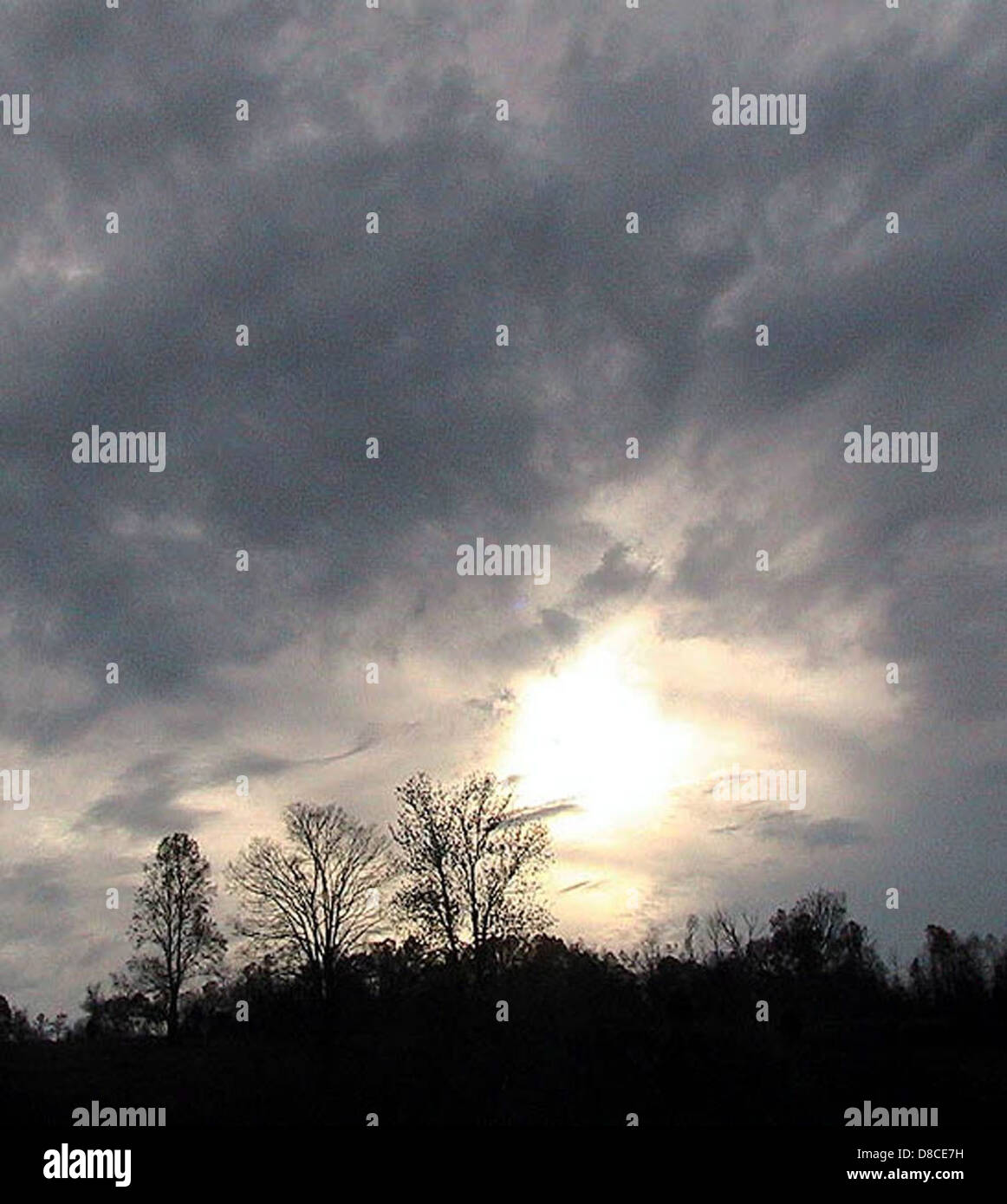 The sky is filled with dark, ominous clouds, creating an intense and ...
