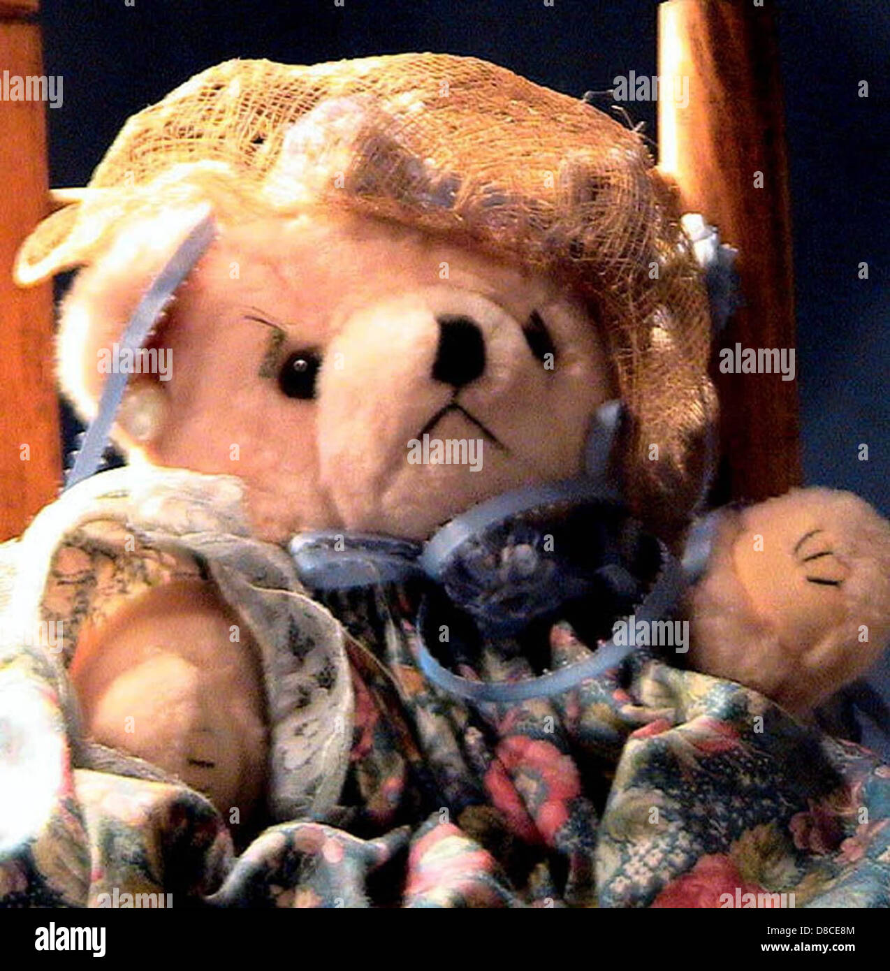 An antique teddy bear, showing signs of wear from years of use. The ...