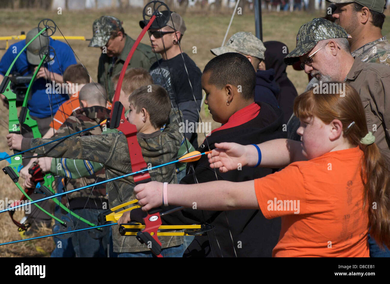 A group of students practicing archery, honing their skills with bows ...