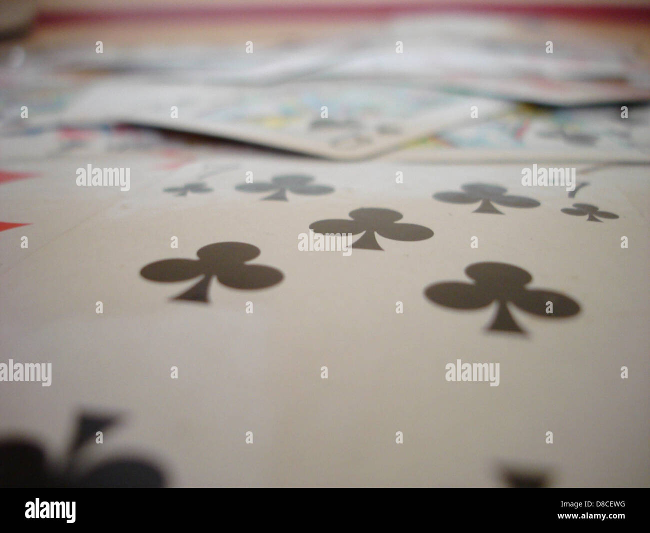 This image shows a scattered pile of playing cards, highlighting their ...