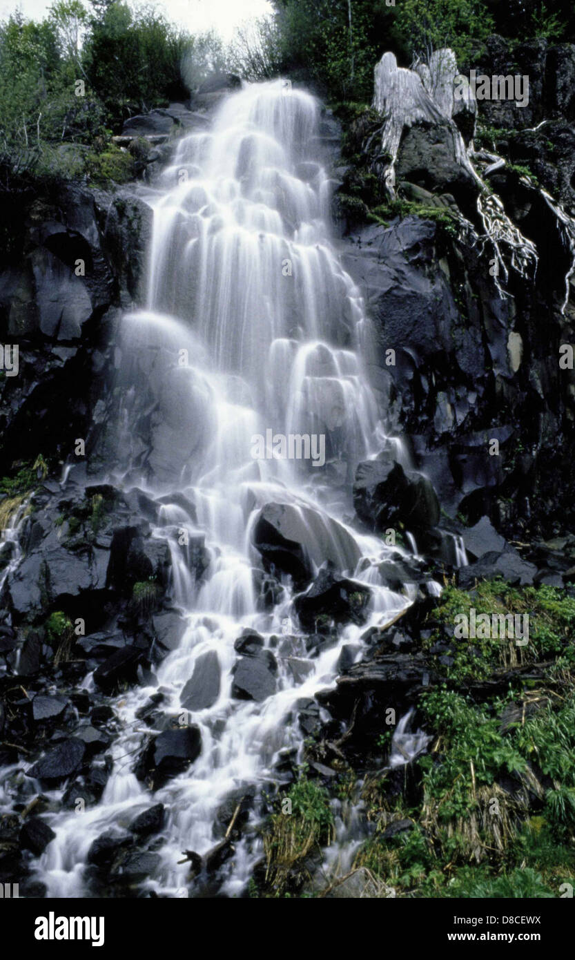 A picturesque waterfall cascades down rocks in central Oregon ...
