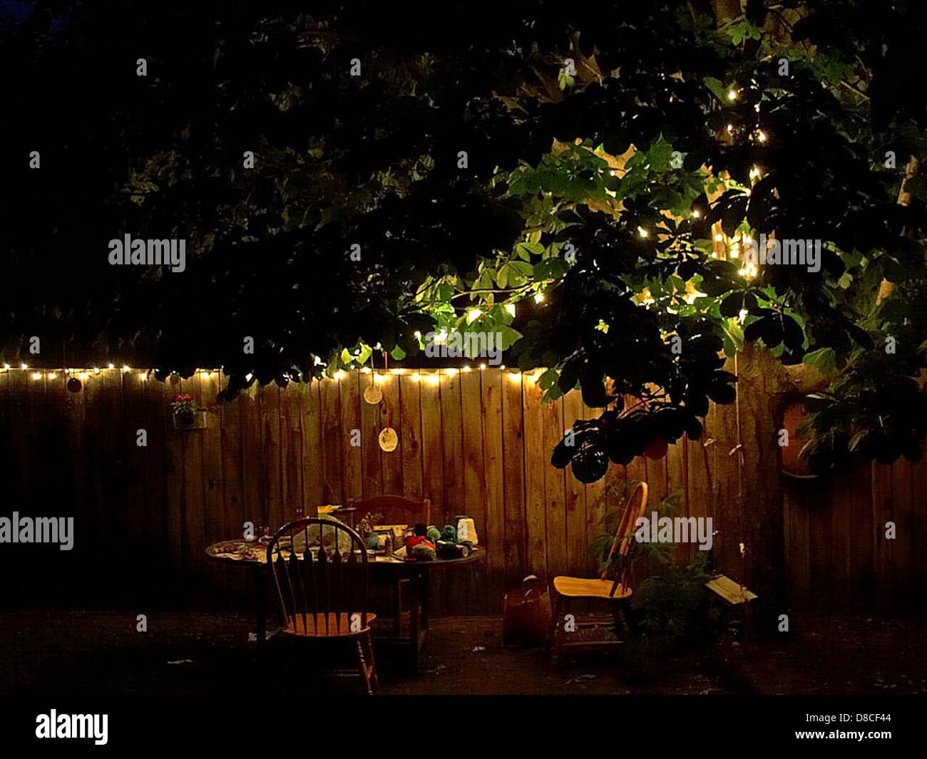Backyard table at night Stock Photo - Alamy
