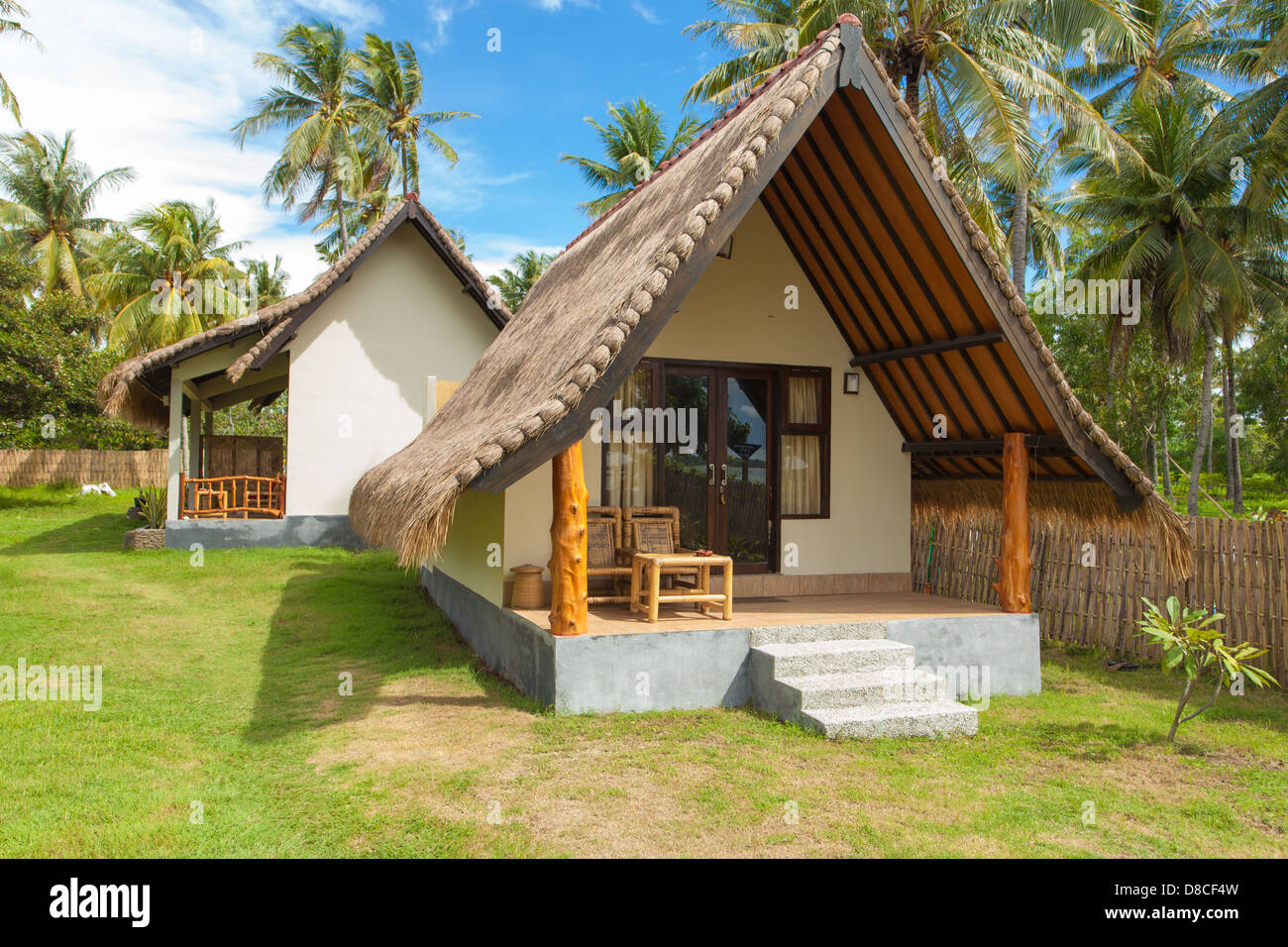 Traditional style accommodation on tropical island Stock Photo - Alamy