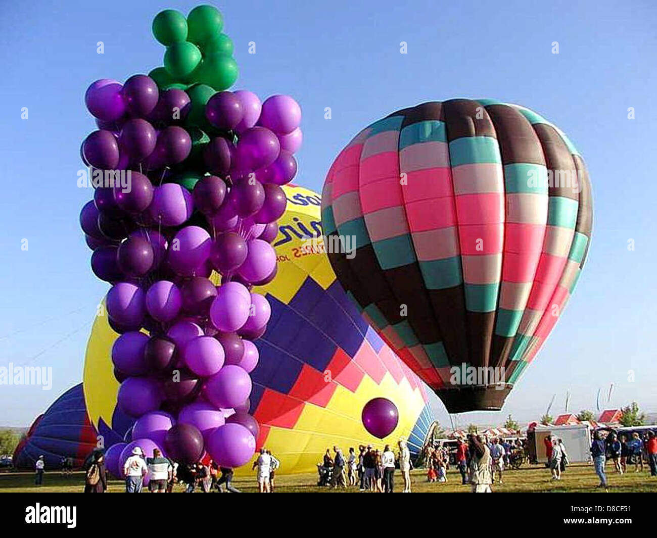 A group of colorful hot air balloons rising in the sky, creating a ...