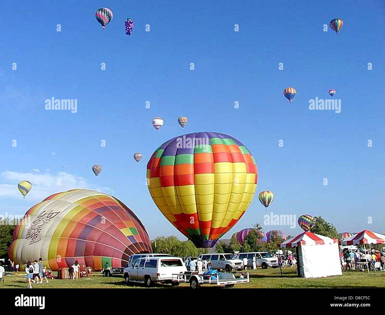 This image captures colorful balloons taking off from the ground ...