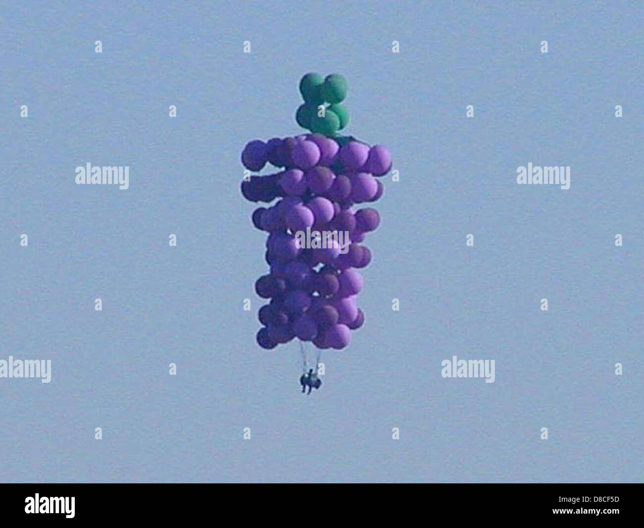 A vibrant hot air balloon race with multiple balloons in the sky ...