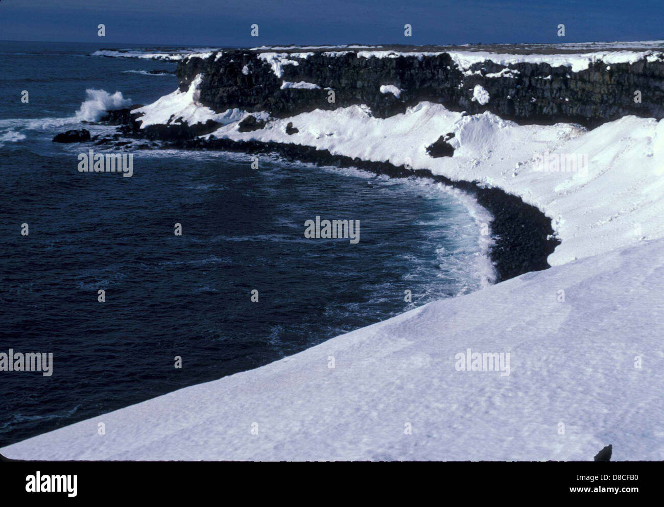 The shore of the Bering Sea is shown covered in ice, with icy water ...