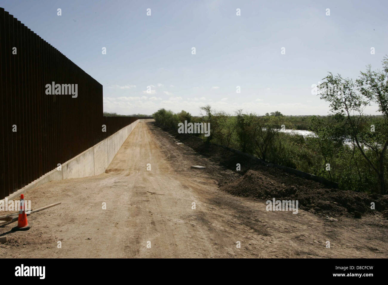 A large border wall at a refugee site, acting as a protective barrier ...