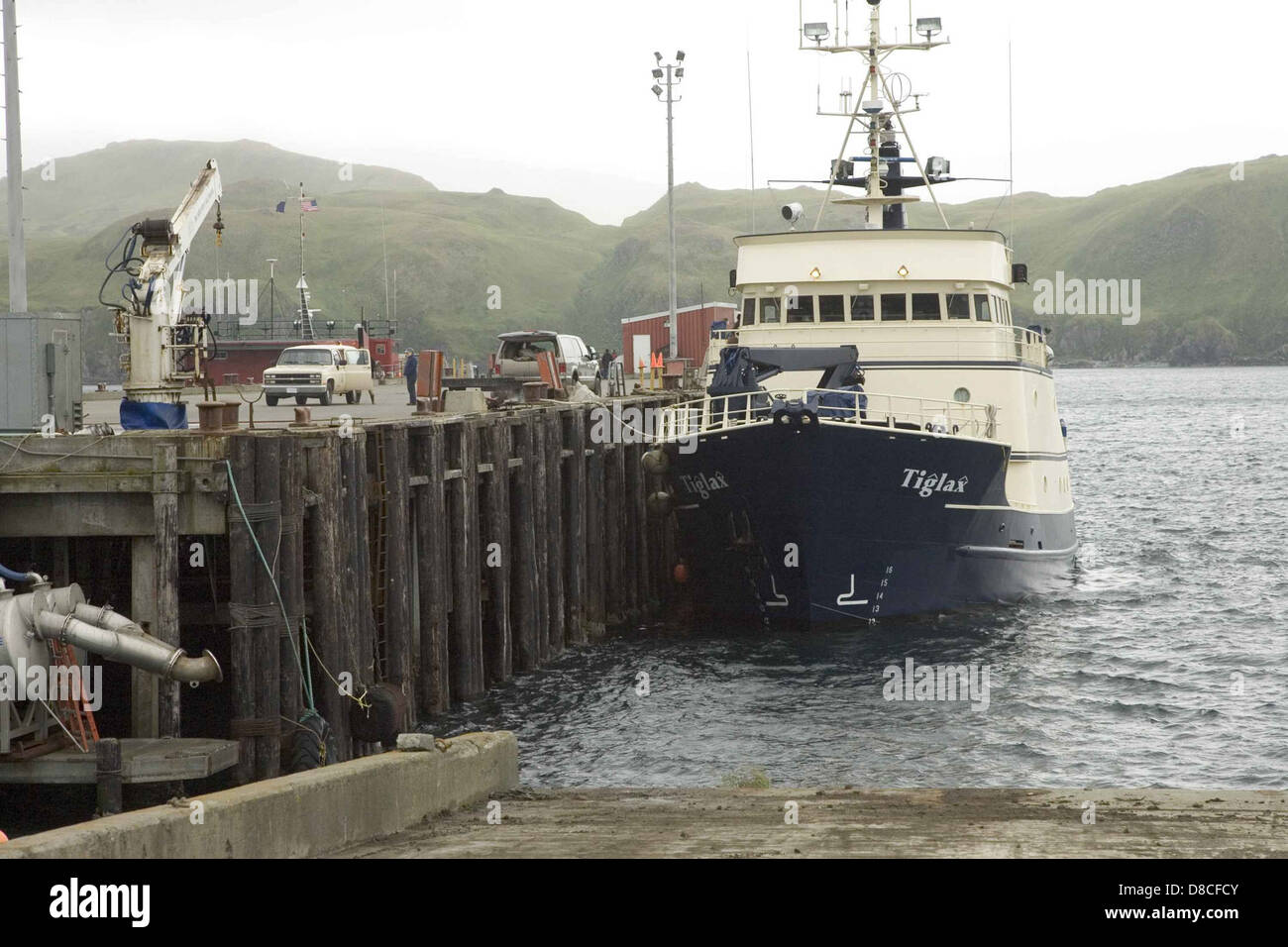 A large research ship is docked at a port, ready for scientific ...