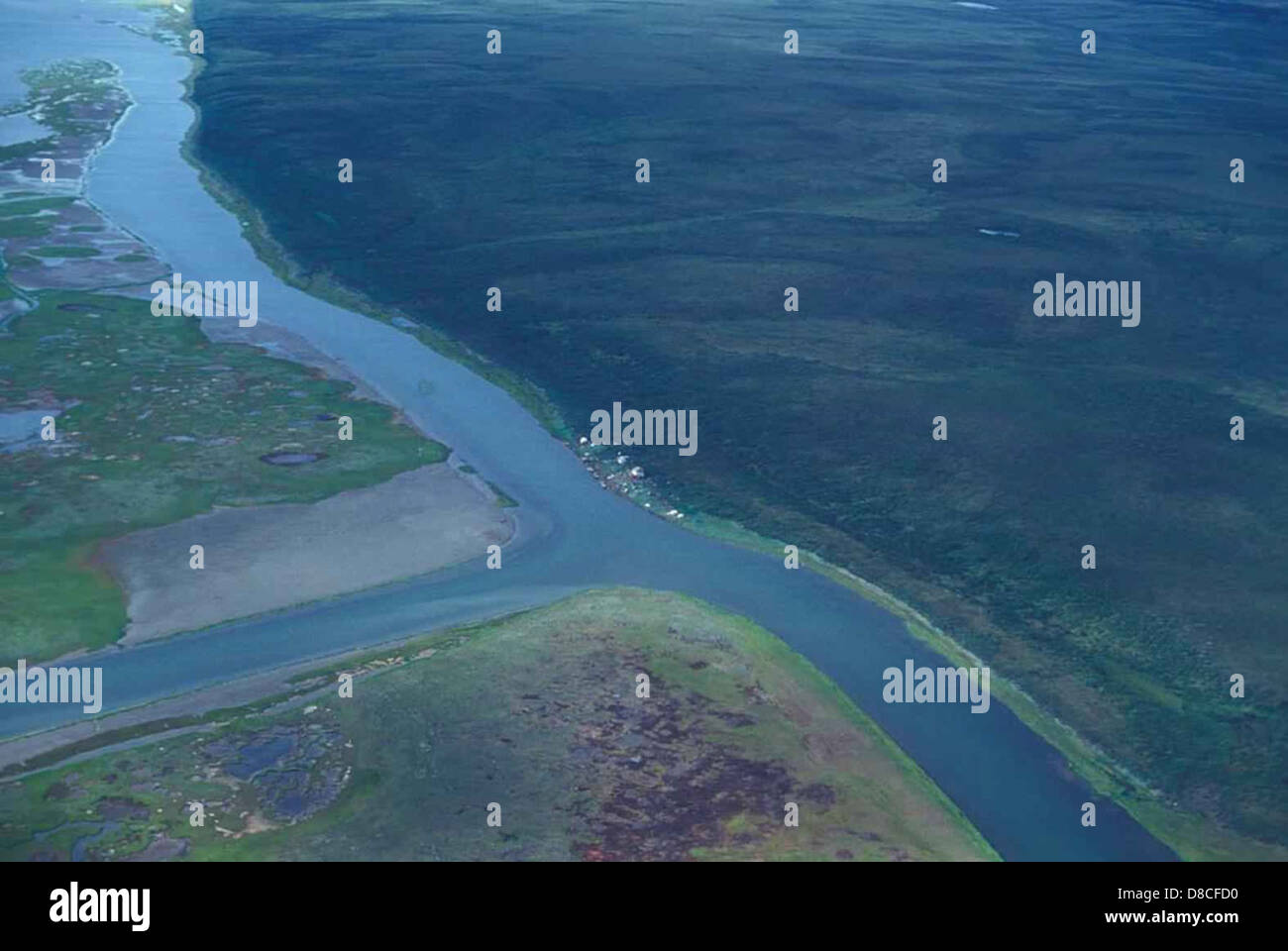 This image provides an aerial view of a large river, showing its ...