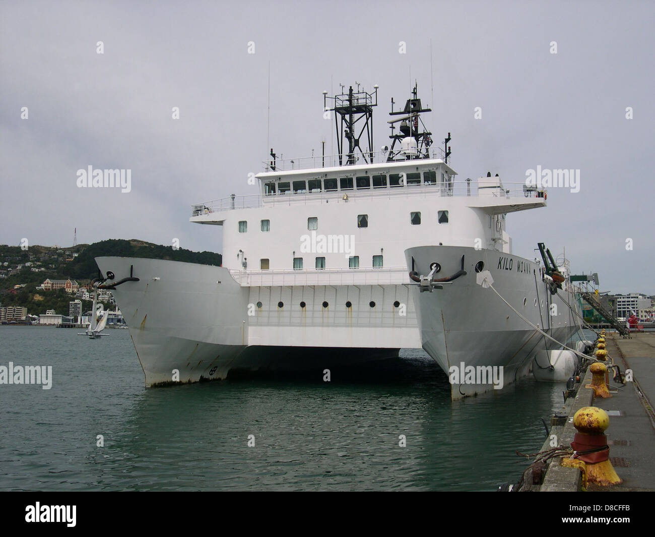 This image shows a large white ship, likely a cruise or cargo vessel ...