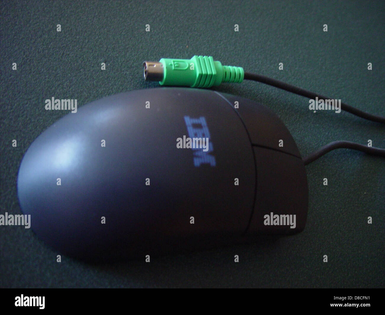 This image features an IBM PS/2 ball mouse, a classic computer ...