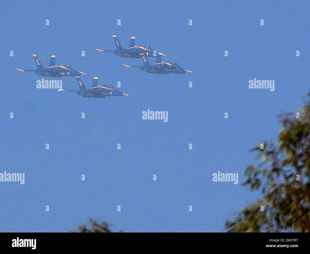 A formation of Blue Angels jets flying in precision during an air show ...