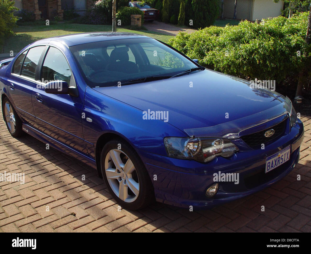 A blue Ford Falcon BA XR6 car displayed in a setting, highlighting its ...