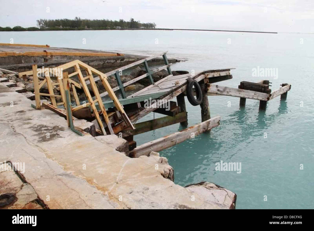 This image shows a damaged boat dock, with visible wear from weather ...