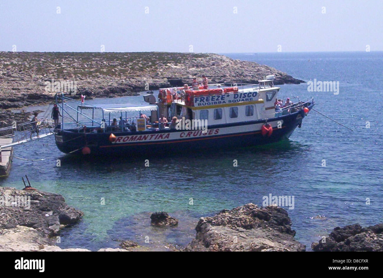 A boat floating on the clear waters of a blue lagoon, surrounded by ...