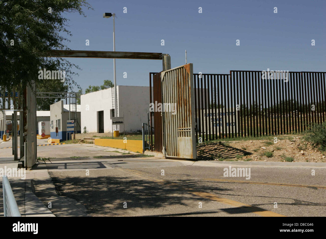 A metal border fence gate, part of a larger structure, designed for ...