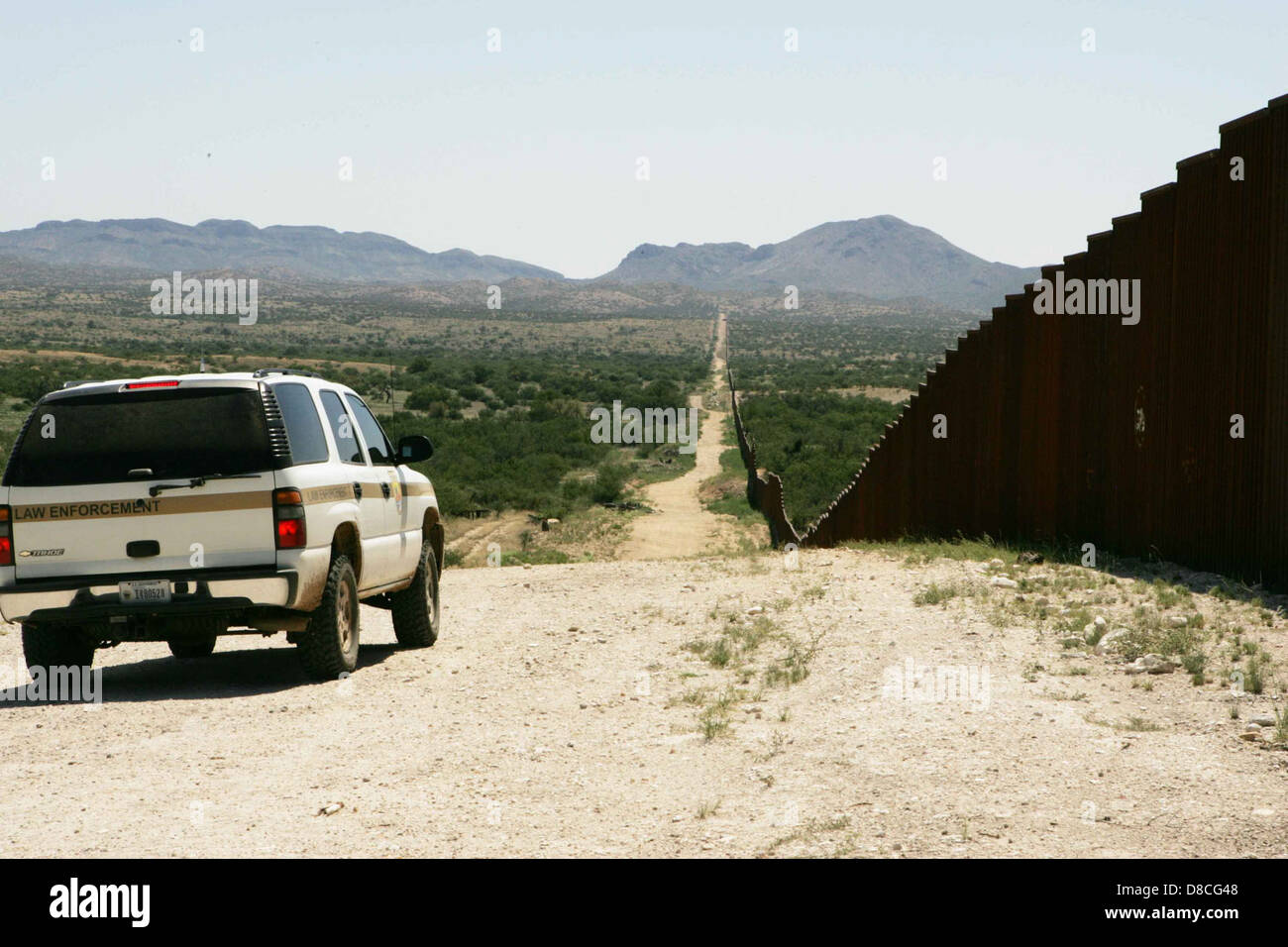 A border patrol vehicle patrolling along a border area, with visible ...