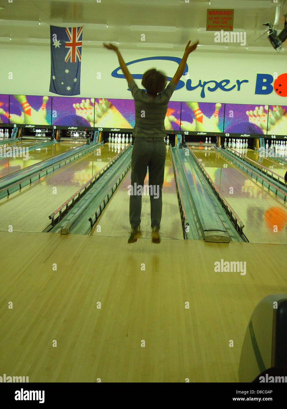 A group of people enjoying a fun moment while bowling, with expressions ...