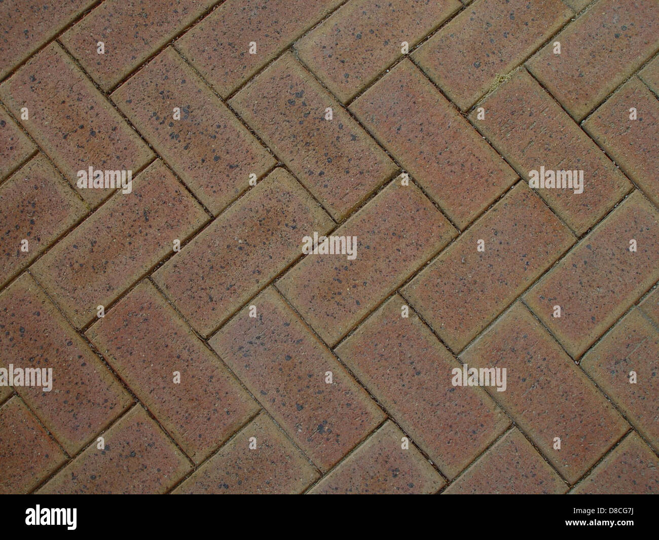 A close-up image of a brick paving surface, showcasing the texture and ...