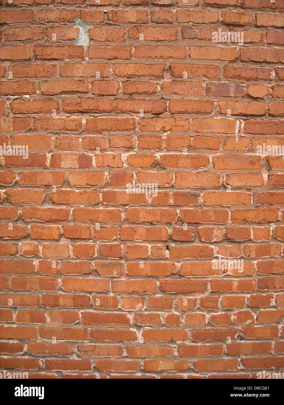 This image shows a textured brick wall, with visible brush strokes ...