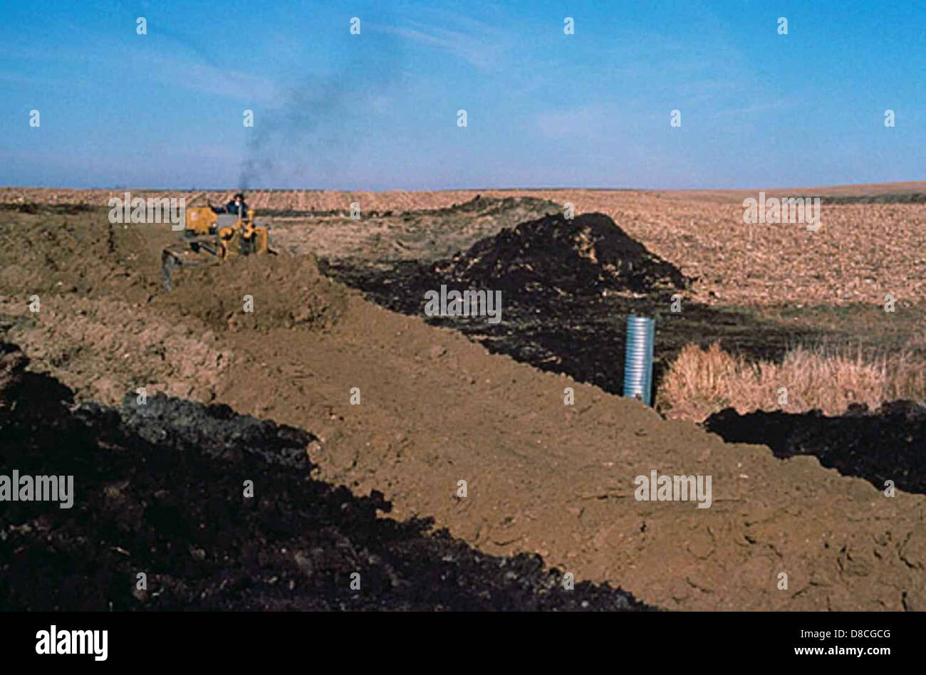 A construction site where a dam is being built, with heavy machinery ...