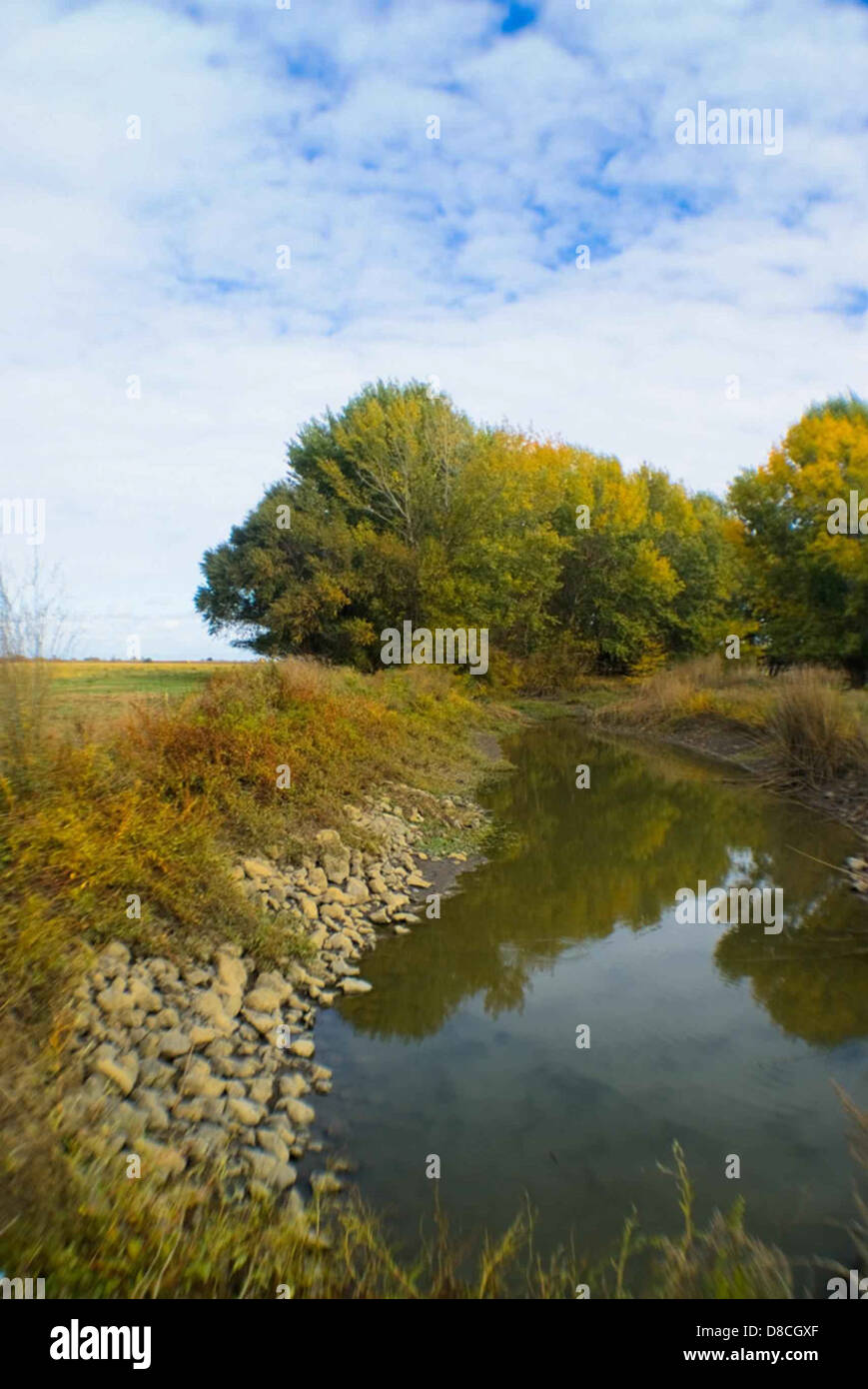 A canal river flows through a controlled channel, often lined with ...