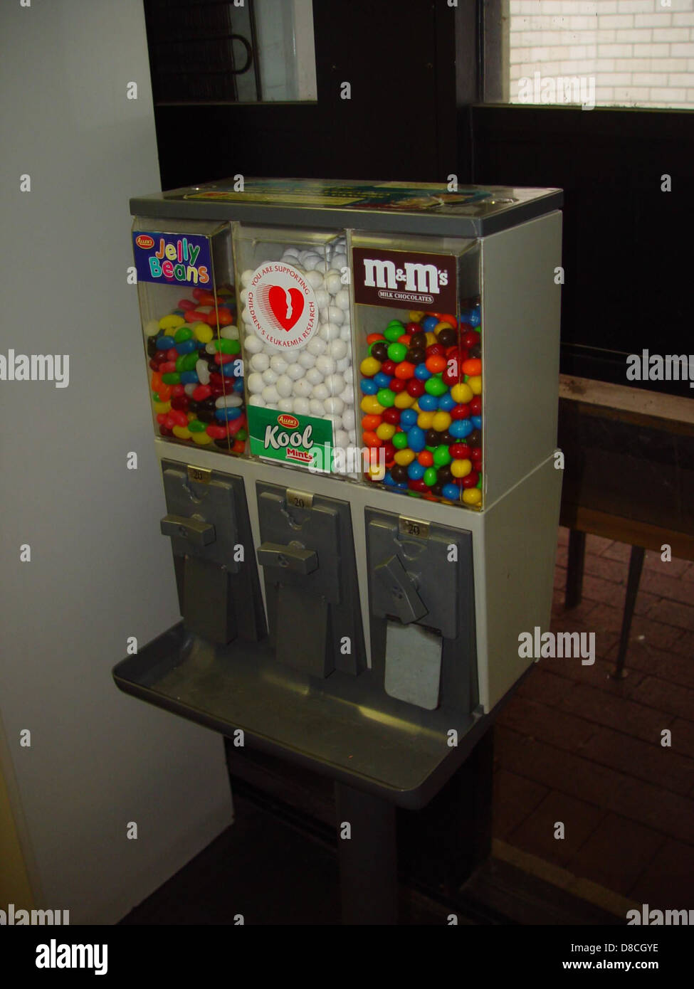 A candy vending machine filled with various colorful candy options. The ...