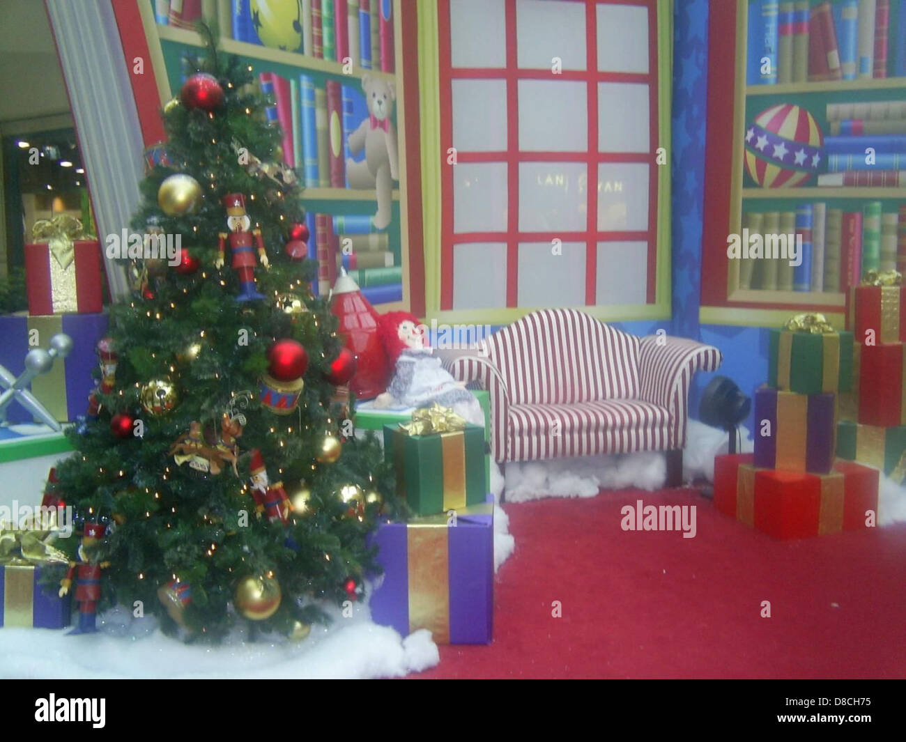 This image shows a festive Christmas set-up with decorations, including ...