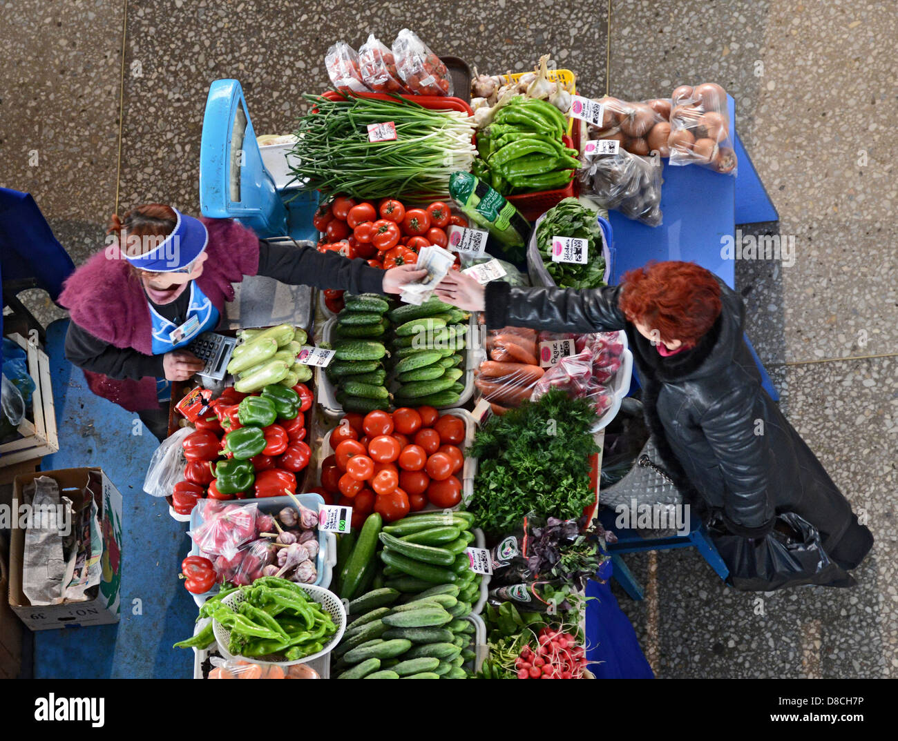 Vegetables seller and customer from above. Noviy Rynok (New Market) in ...