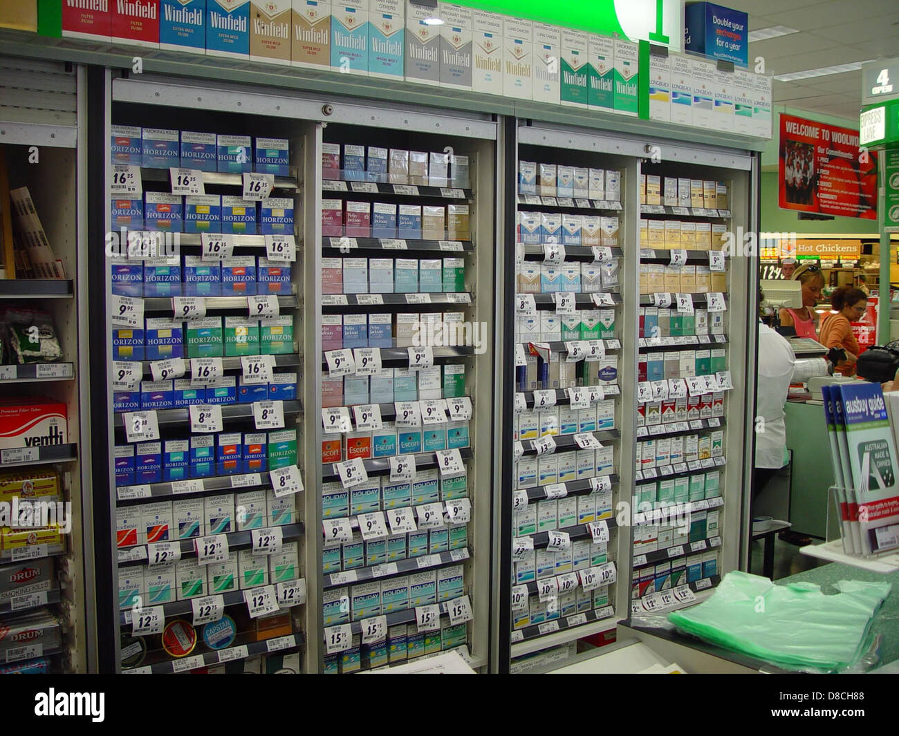 A cigarette counter is lined with various brands of cigarettes ...