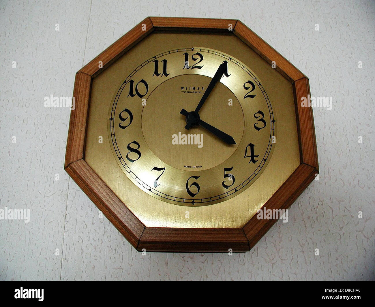 This image shows a classic analog clock, with hour and minute hands ...
