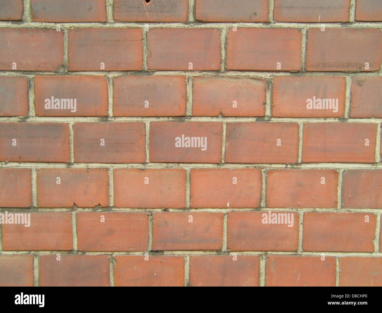 A close-up of red cobbled bricks, showcasing their rough texture and ...