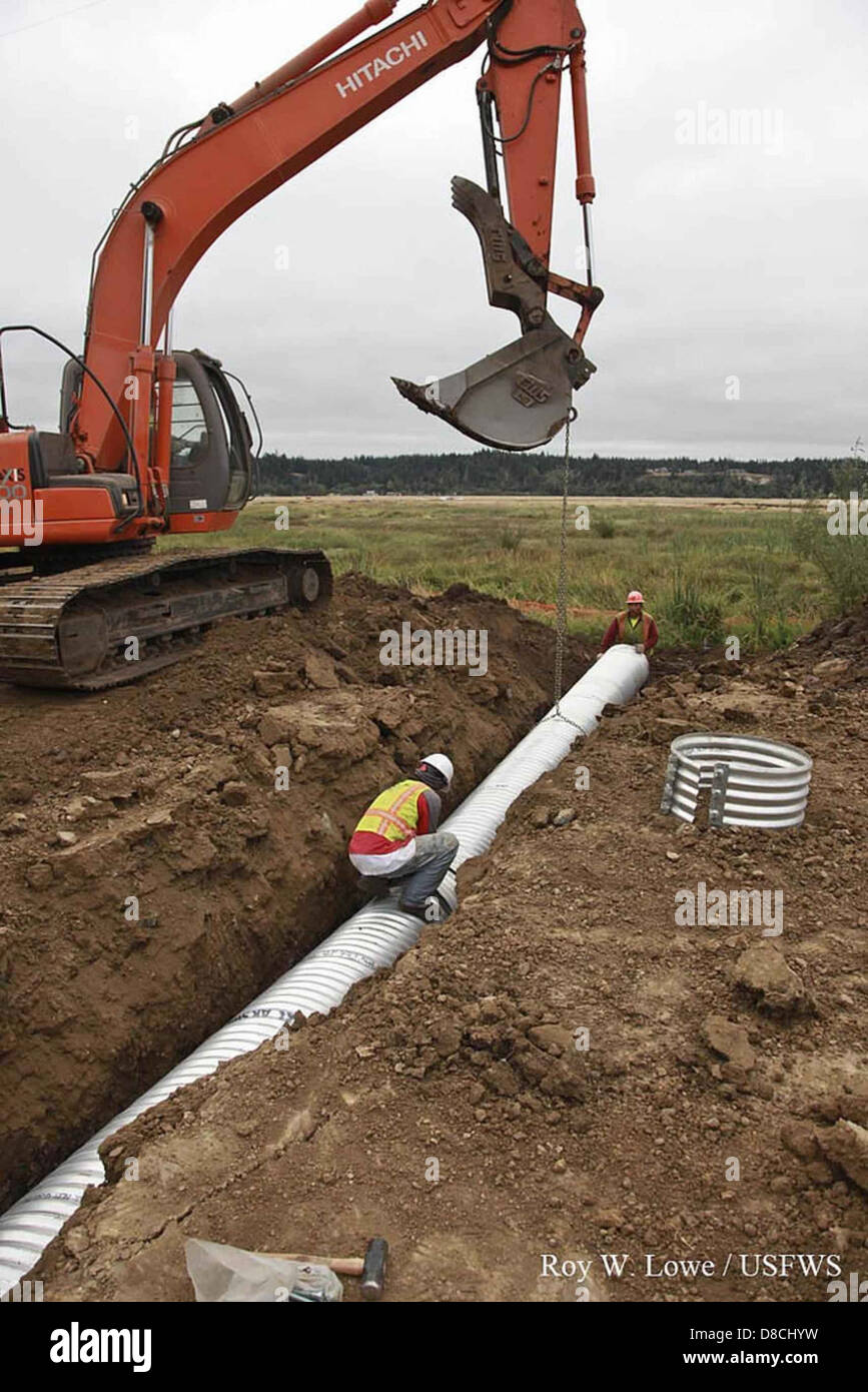 Construction workers are seen working on floodplain overflow ...