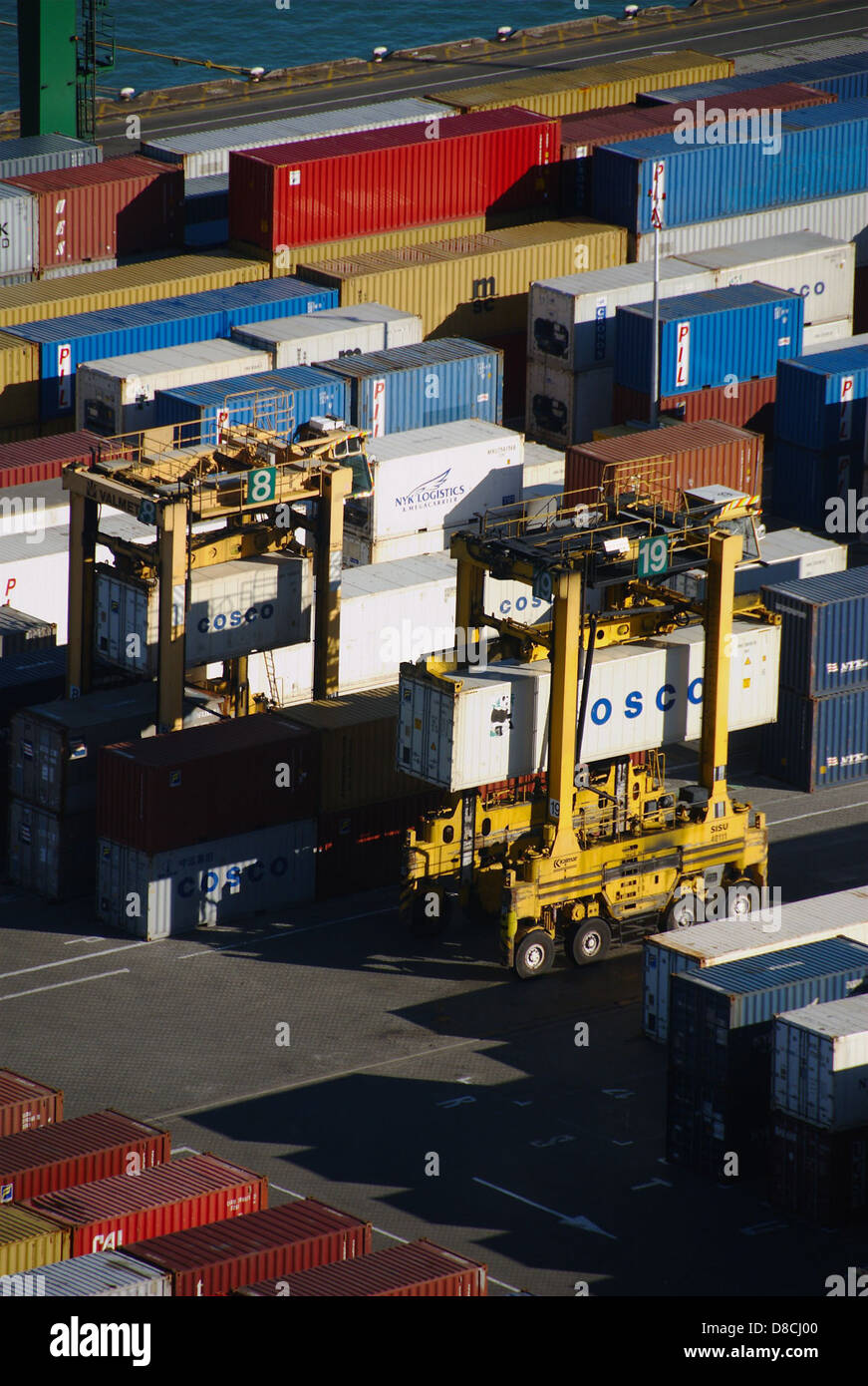A container port with rows of stacked shipping containers, showcasing ...